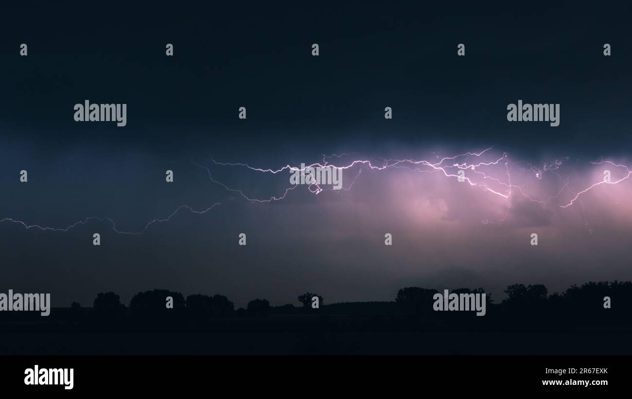 A stunning image of a lightning bolt illuminated in the purple night ...