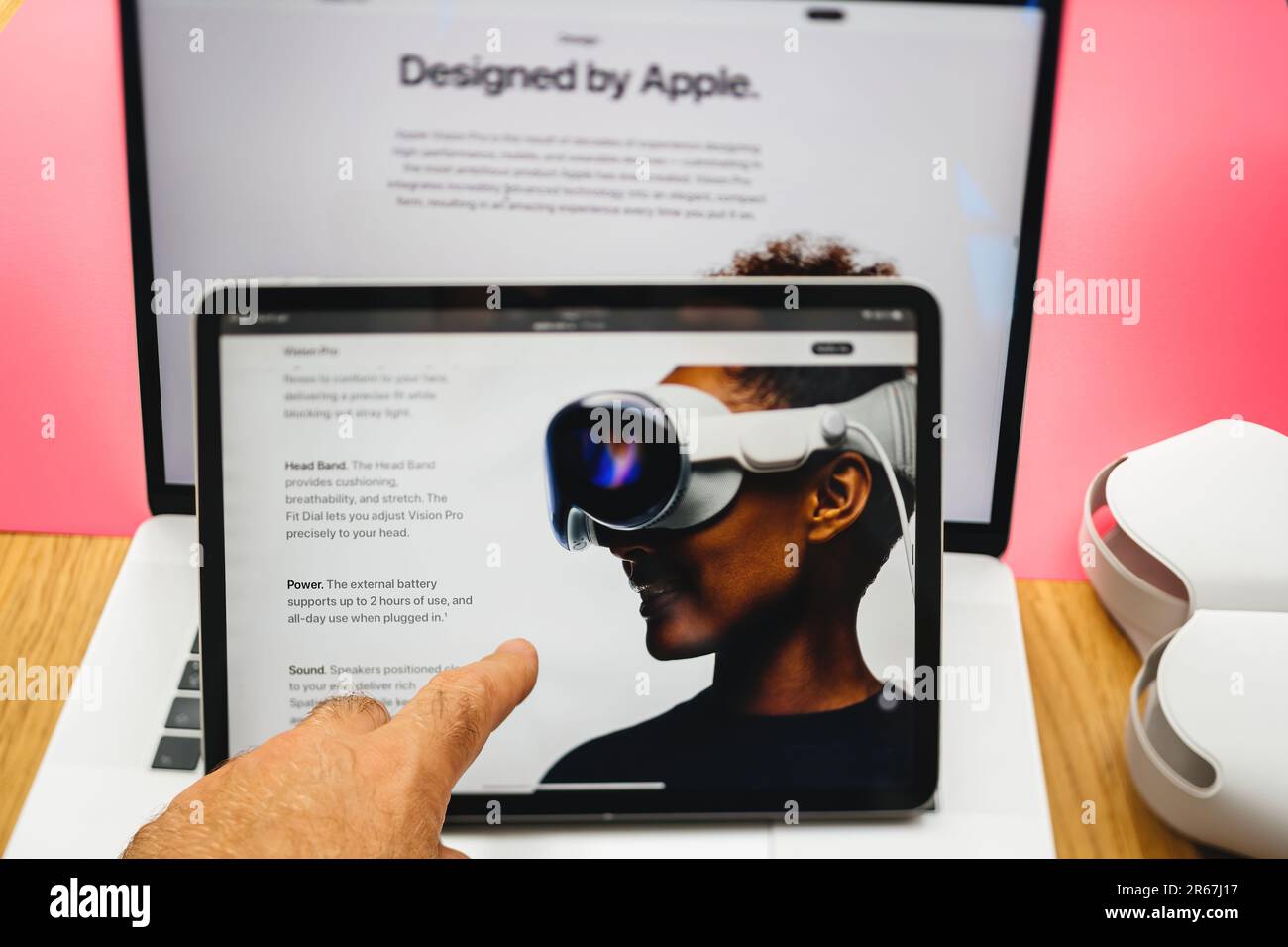 Paris, France - Jun 6, 2023: Hand pointing to desing webpage of Apple ...