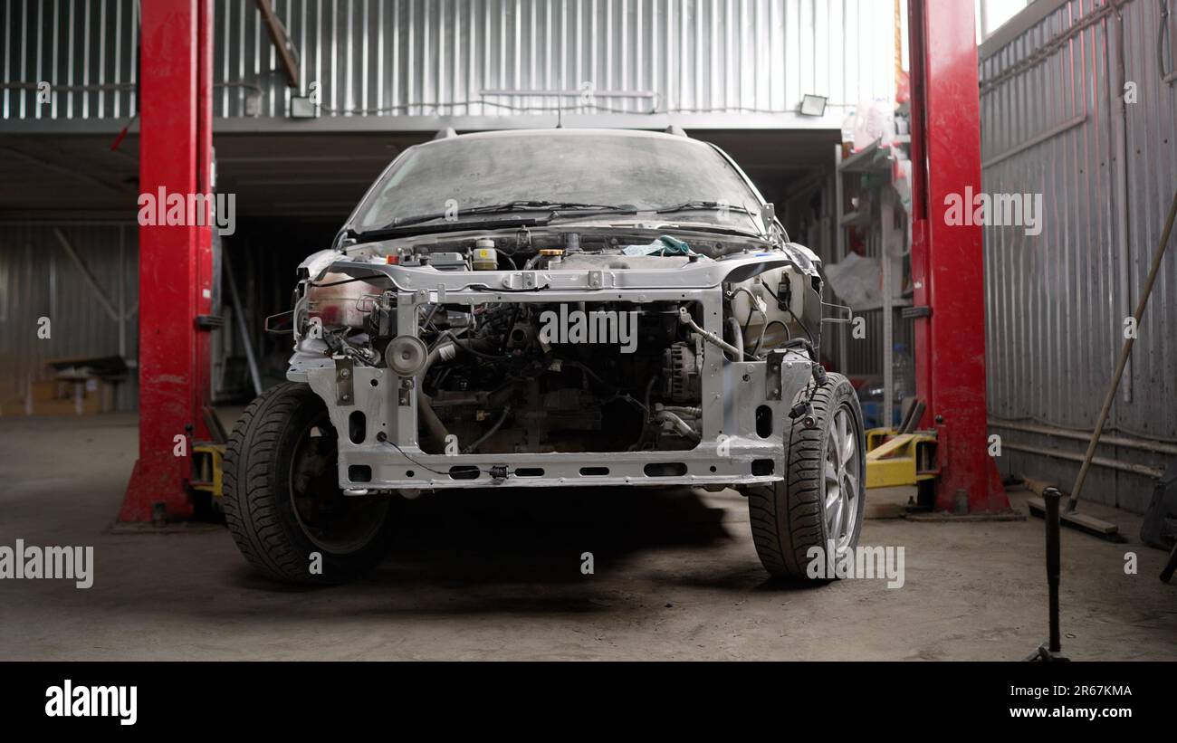 The frame of a powerful white car with body parts removed. Car bumper ...