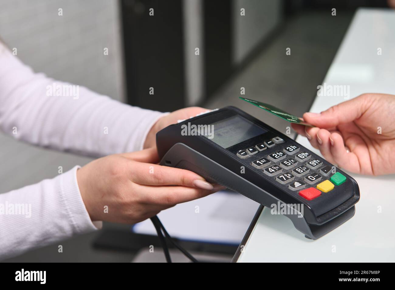 Selective focus on POS terminal, credit card reader in the hands ...