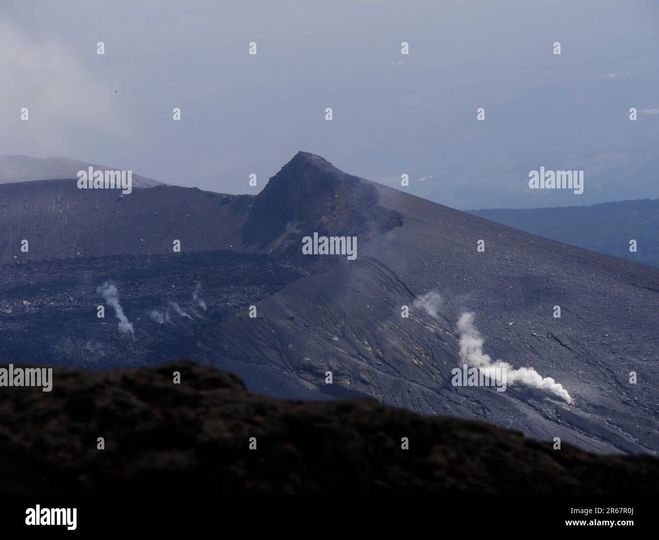 The smoking volcano of Shinmoedake from Karakunidake trail Stock Photo ...