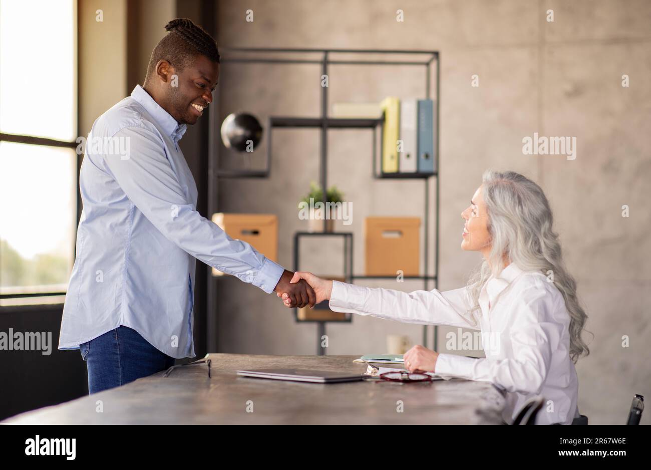 Manager shaking hands employee workplace hi-res stock photography and ...