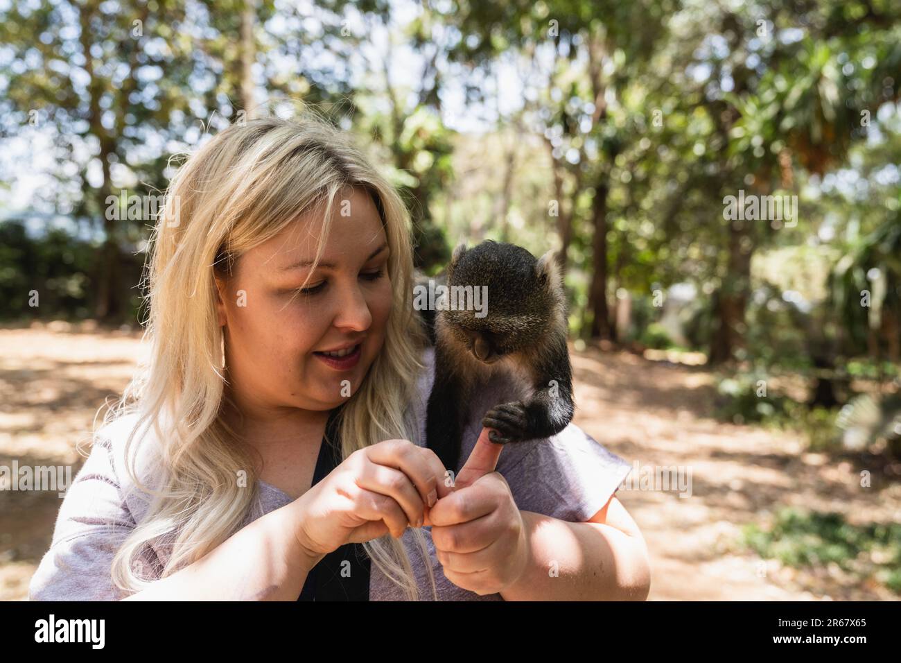 Blonde woman with a Syke Monkey on her shoulder, in City Park Nairobi ...