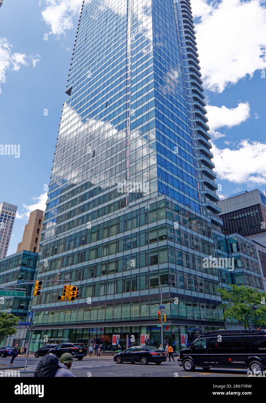 The blue glass residential tower 252 East 57th Street sits atop a half ...