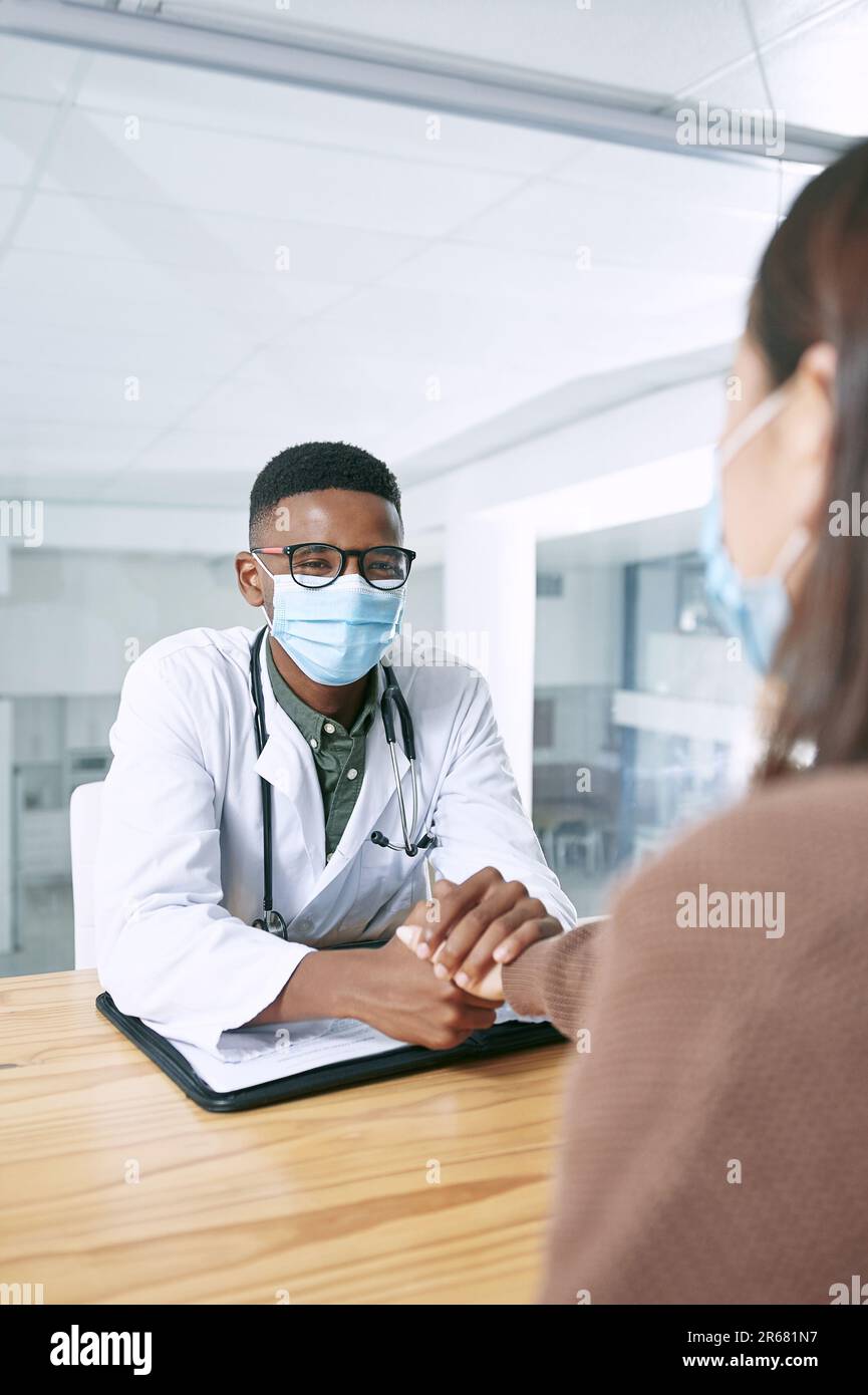 How have you been coping. a young doctor sitting with his patient and ...