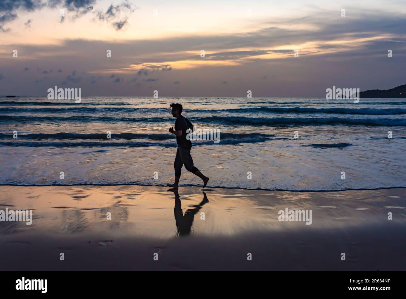 Seascape silhouette lonely man sunset hi-res stock photography and ...
