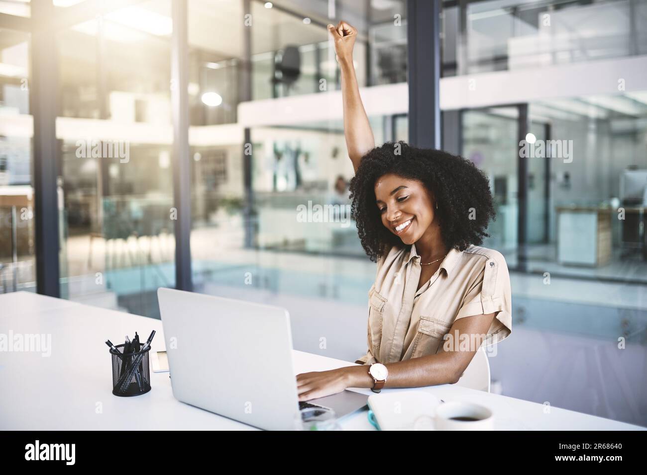 Success grows when you celebrate it. a happy young businesswoman ...