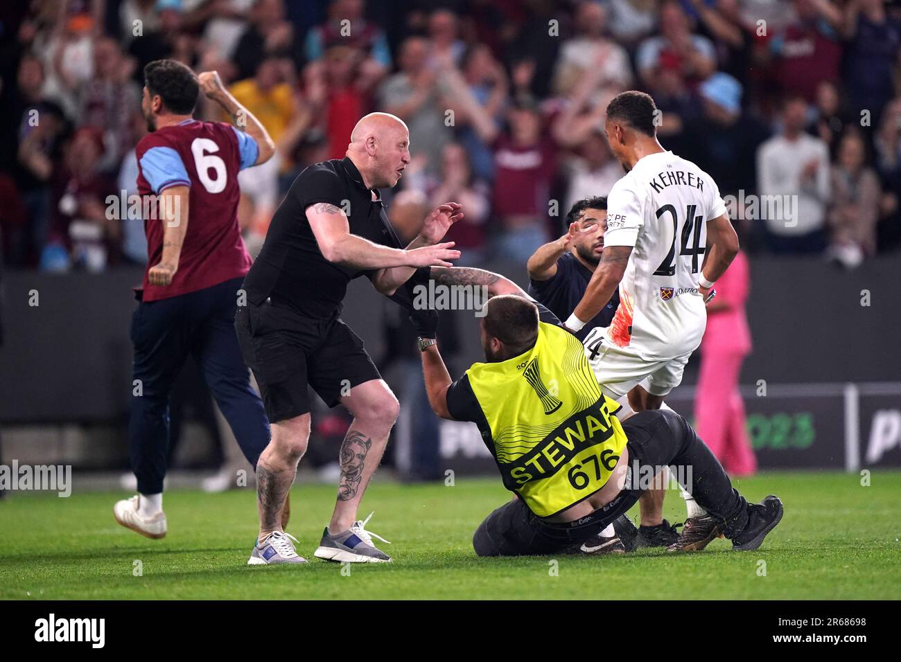 West Ham United's Thilo Kehrer is accidentally tackled by a security ...