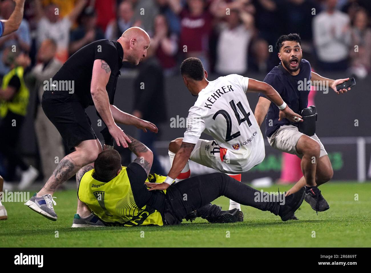West Ham United's Thilo Kehrer is accidentally tackled by a security ...