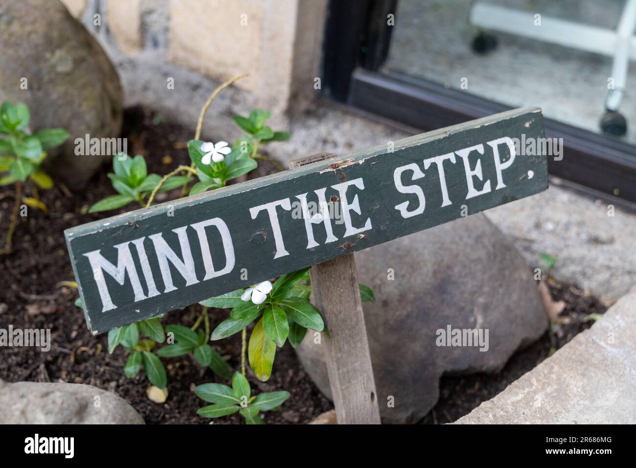 Mind the Step sign to warn people of uneven surfaces ahead Stock Photo ...