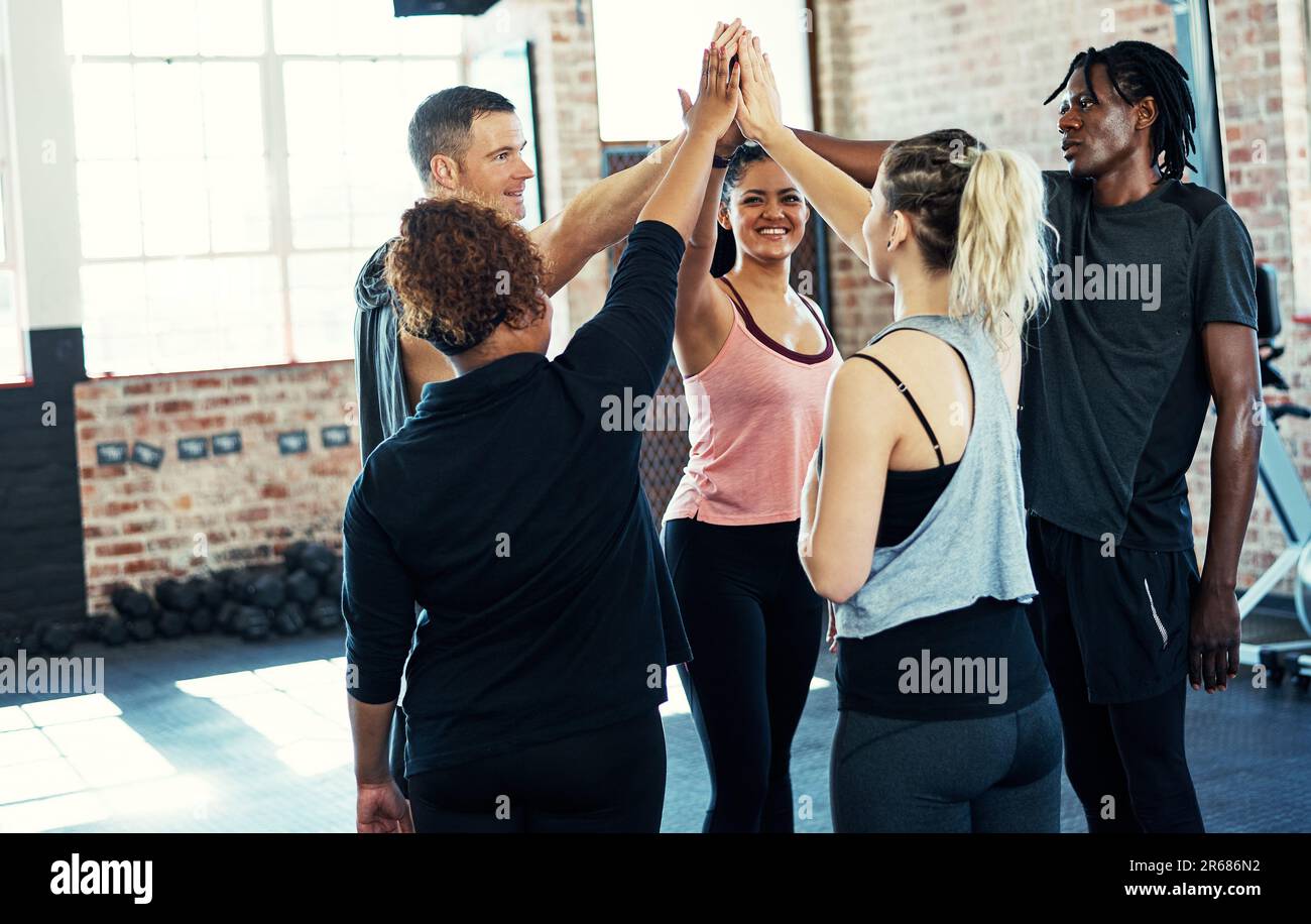 We got this guys. a cheerful young group of people forming a huddle ...