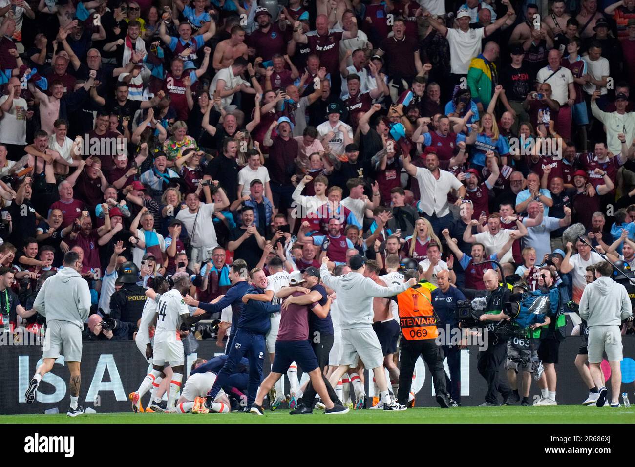 West Ham fans run on to the pitch to celebrate with the players at the ...