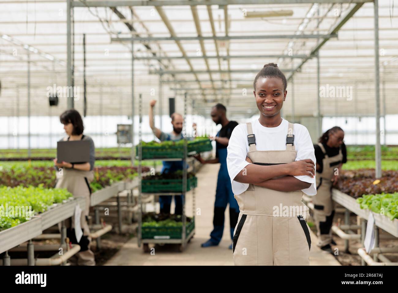 Happy smiling entrepreneur farm manager leading group of farm workers ...