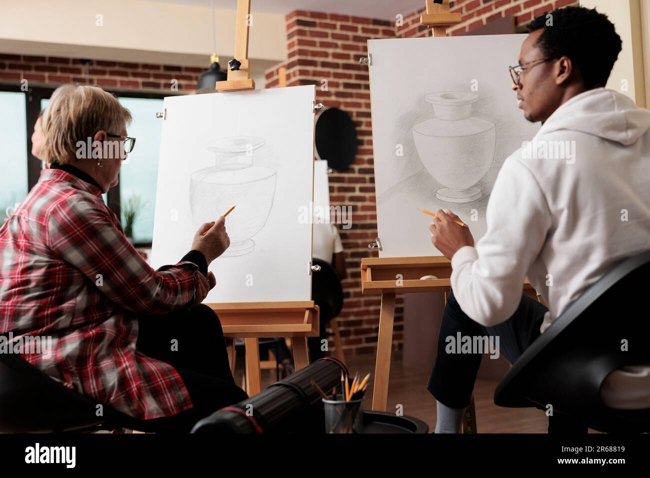 Diverse different generation people drawing on canvas and talking ...