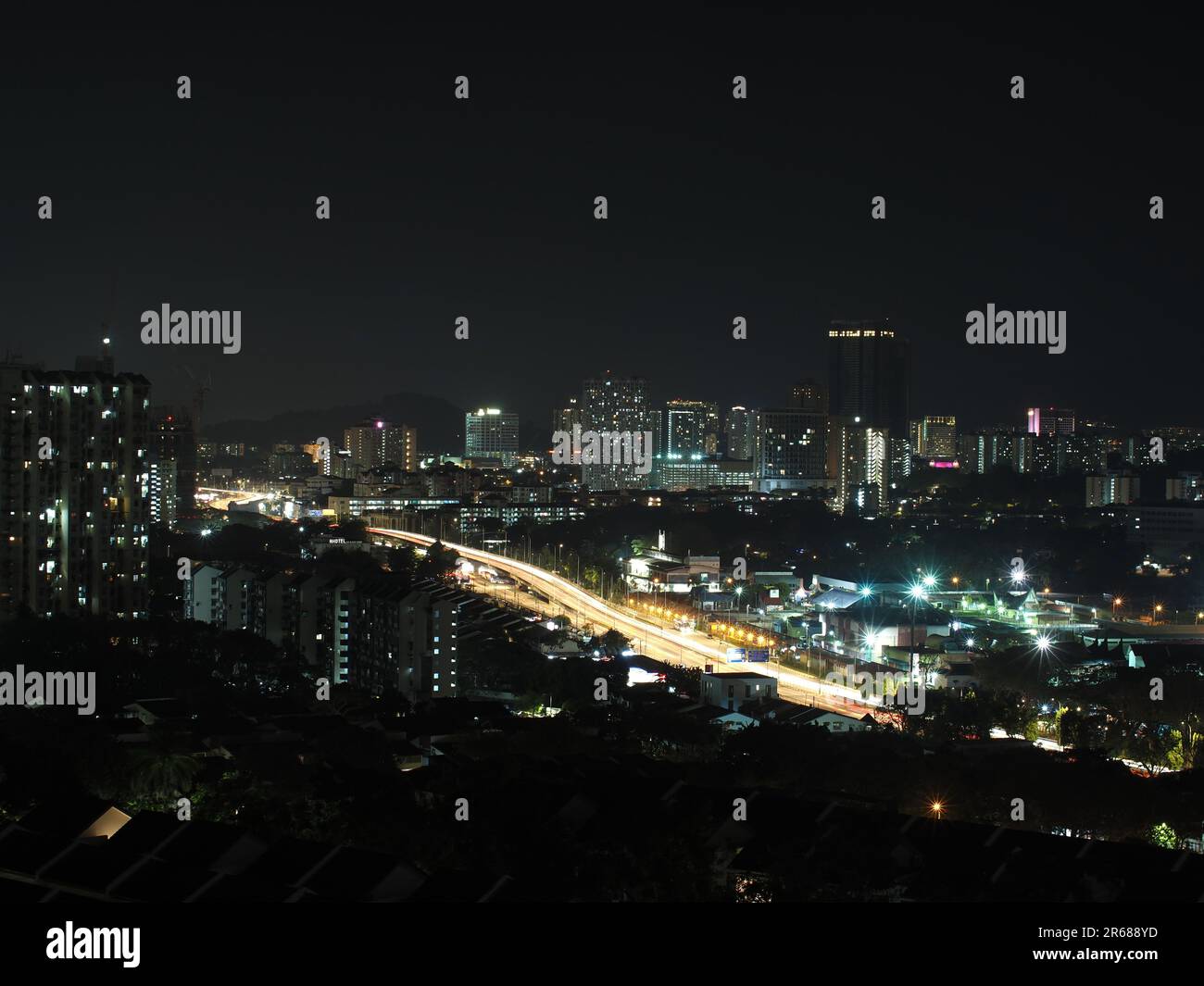 An illuminated night skyline of a bustling metropolitan city, featuring ...