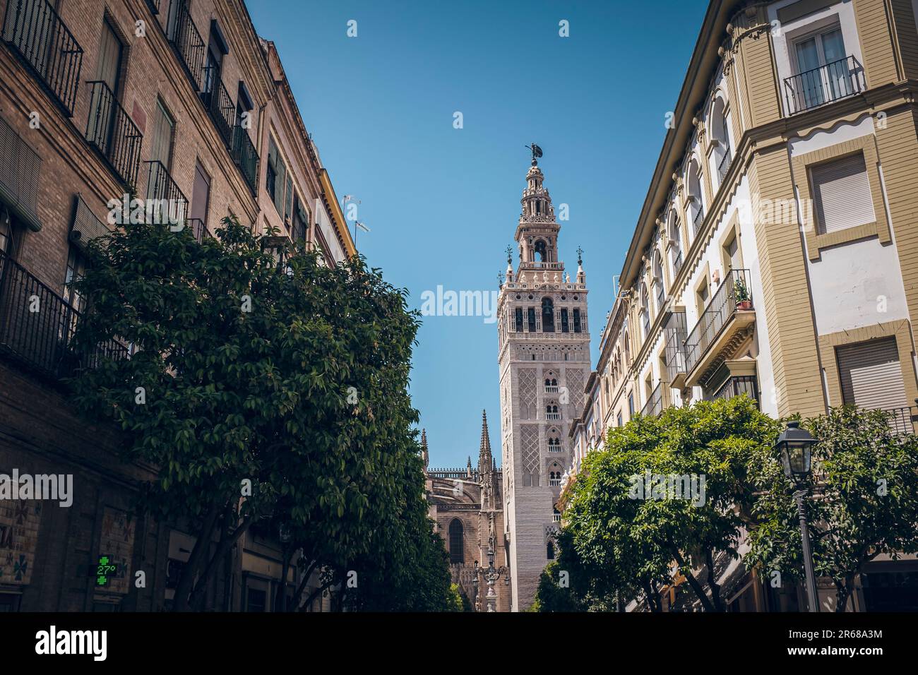 Image of the Giralda Tower of Seville through the streets of Seville ...