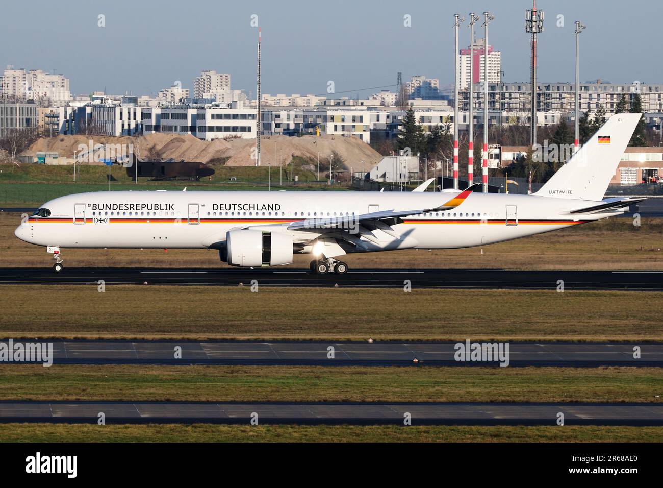 A commercial airliner taking off from a runway, with cityscape in the ...