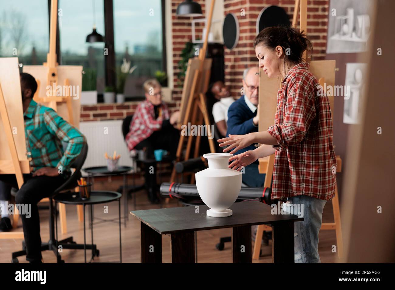 Diverse people learning how to draw realistic objects during group ...