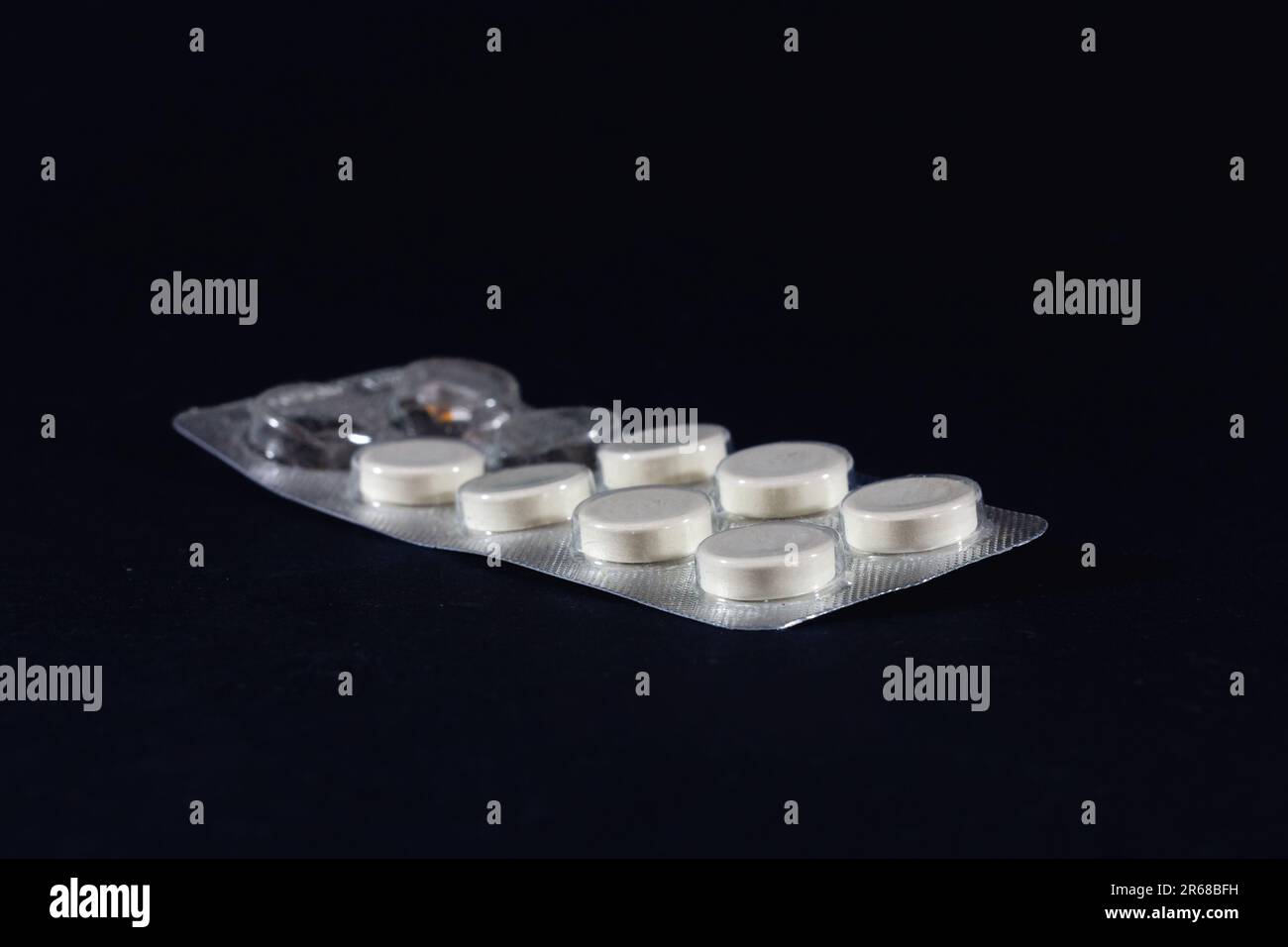 picture of a half empty blister pack of tablets, white pills, of pain ...