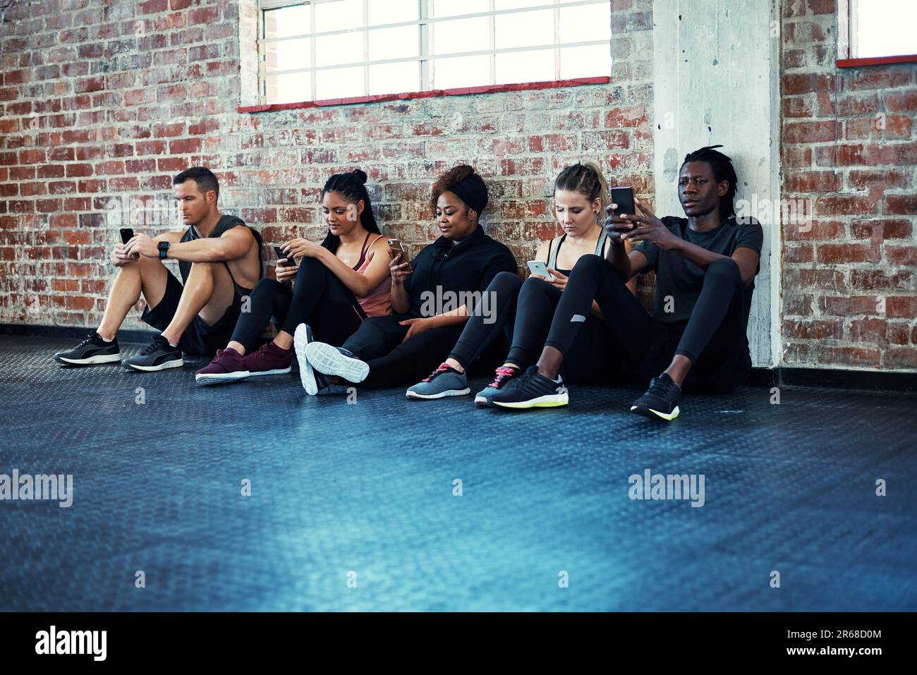 Everyone relax a bit. a cheerful young group of people sitting down the ...