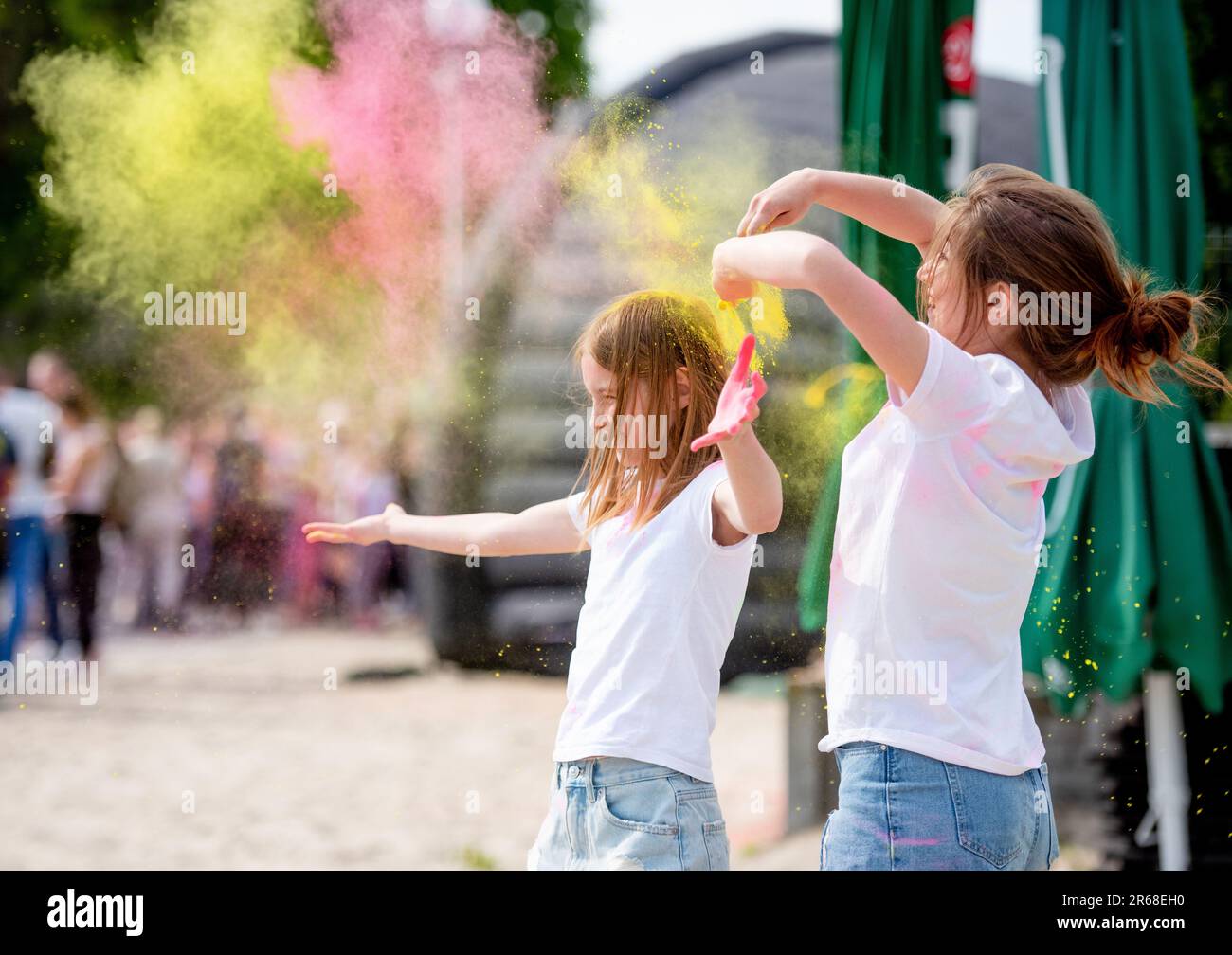 Pretty sisters in indian traditional Holi festival with colorful powder ...