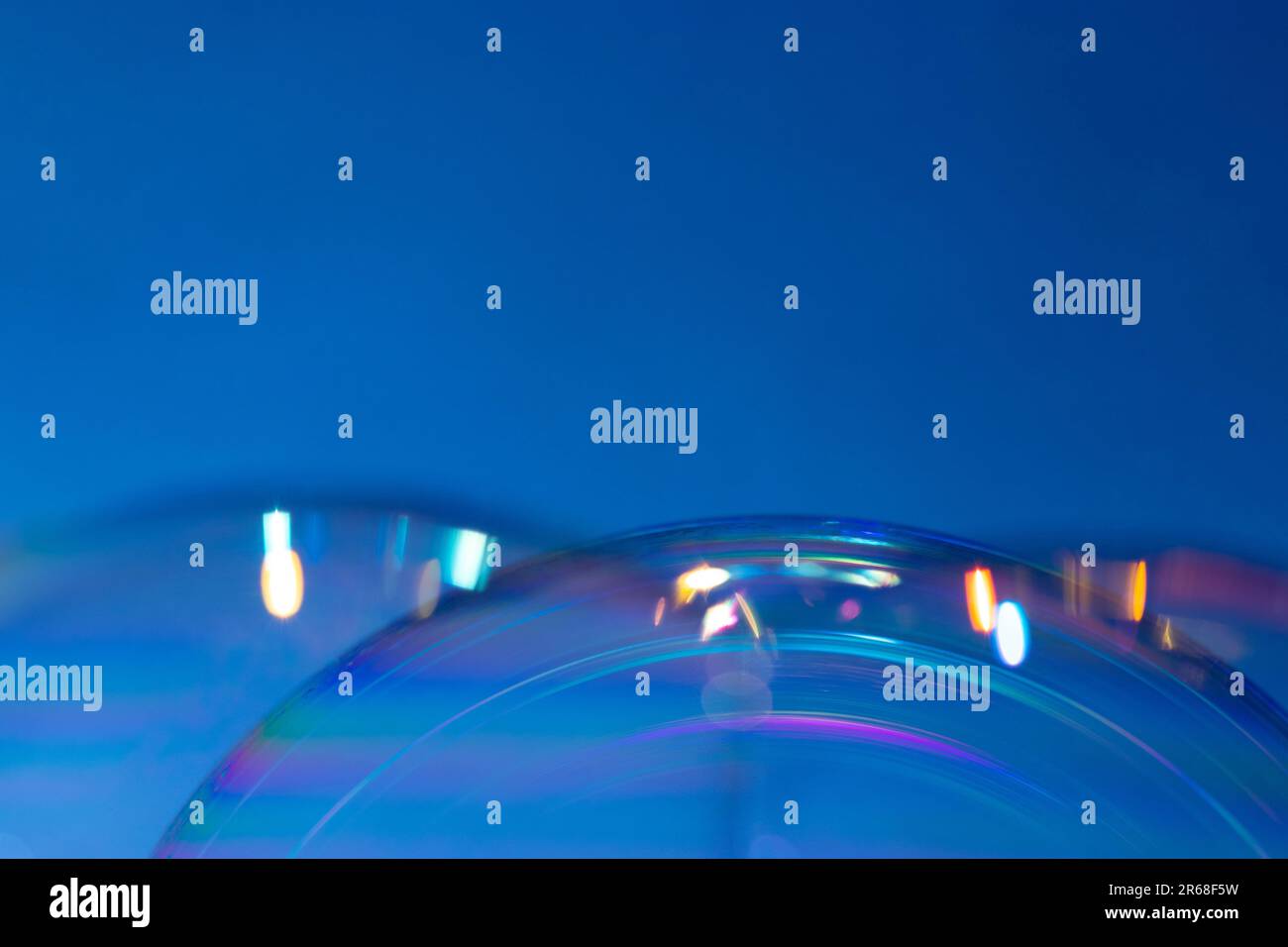 An abstract wallpaper image of a blue bubble with white lights ...