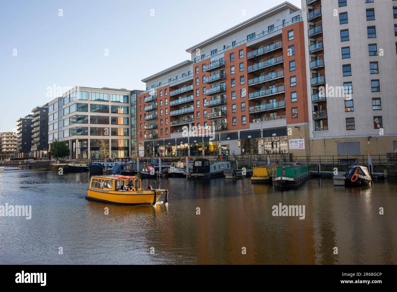 Taxi boat and modern apartment buildings at Leeds Dock, Leeds Stock ...