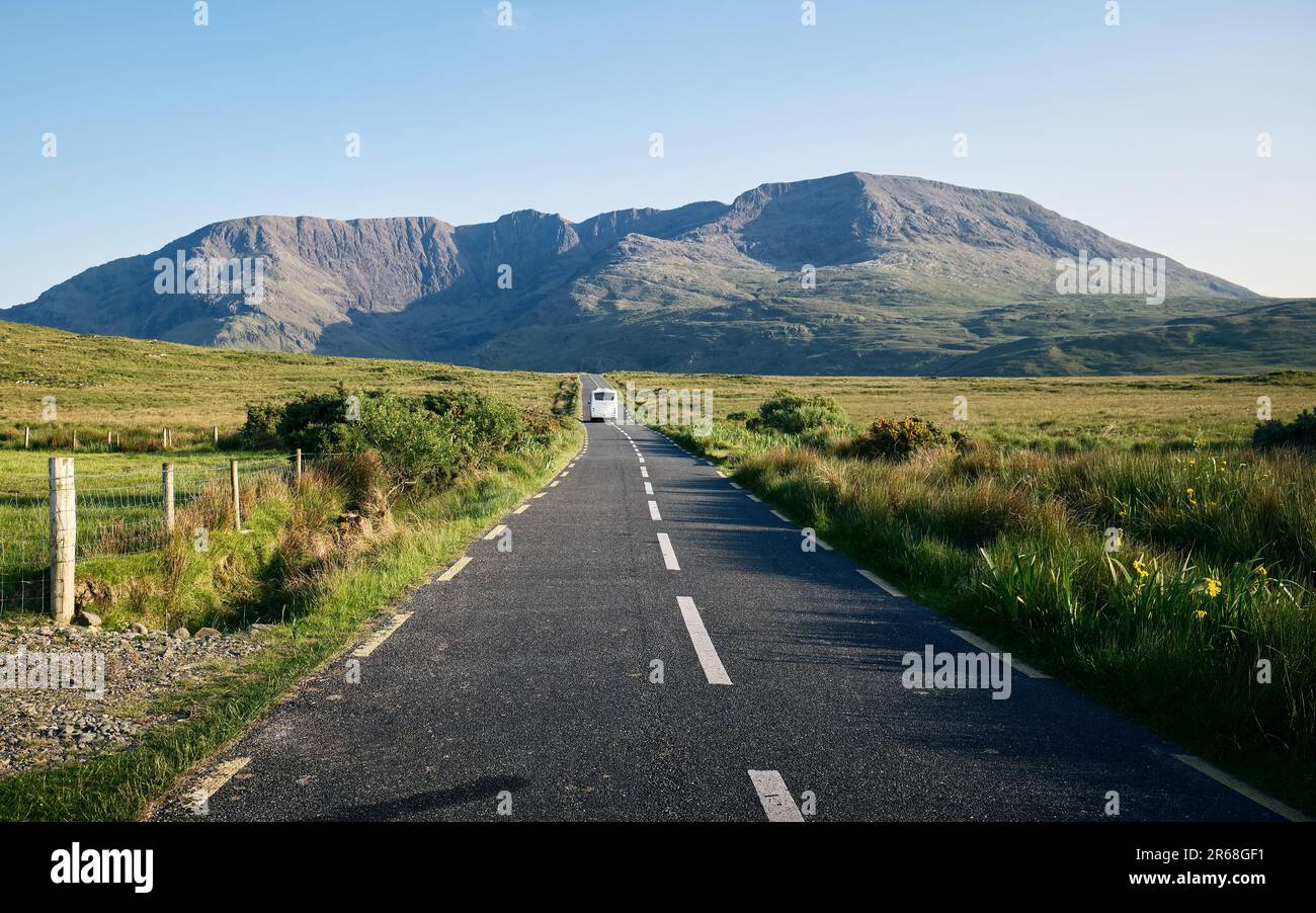 Beautiful landscape scenery with bus driving on empty scenic road ...