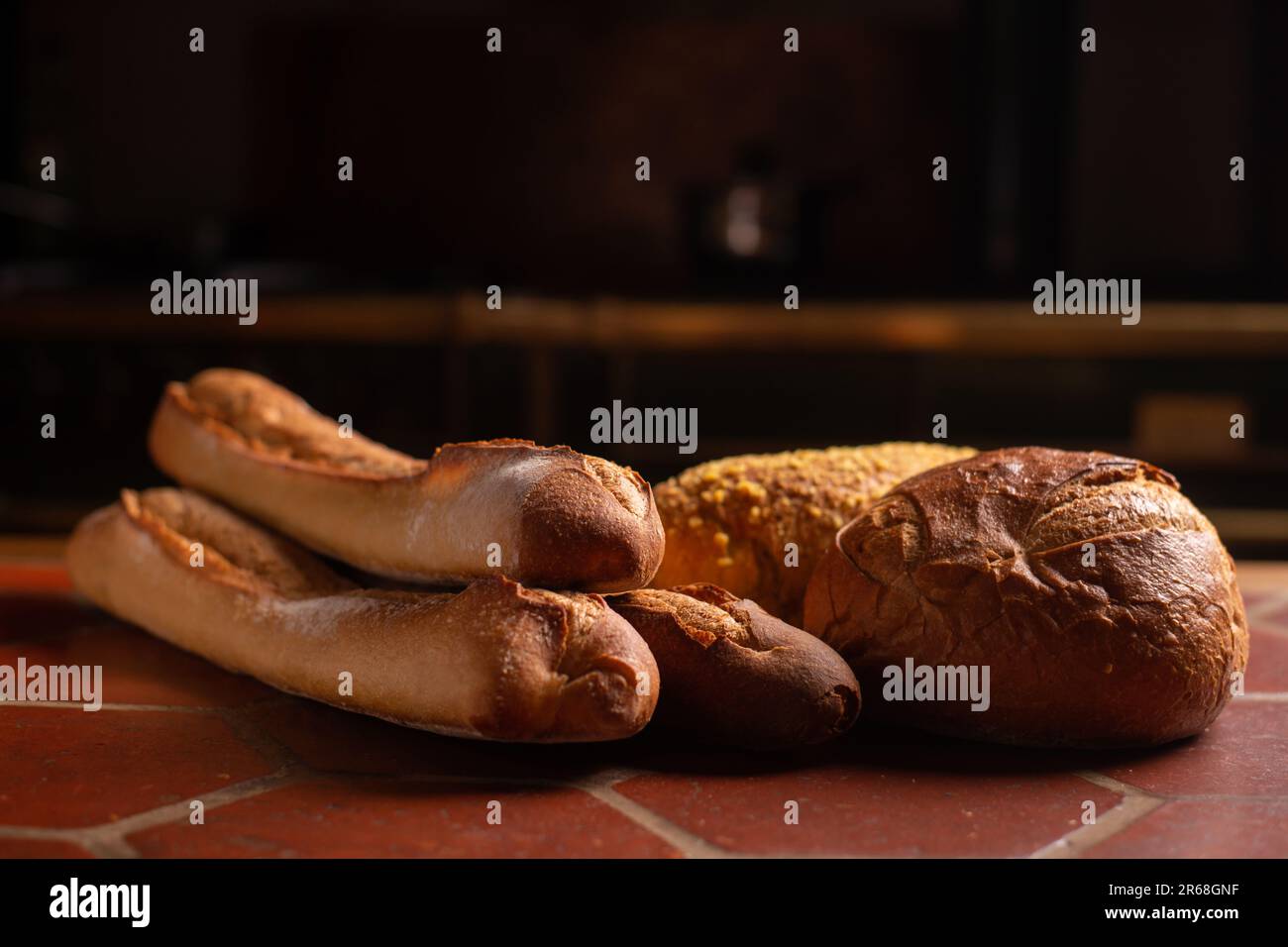 Different types of french bread on the table. Baguettes, round bread ...