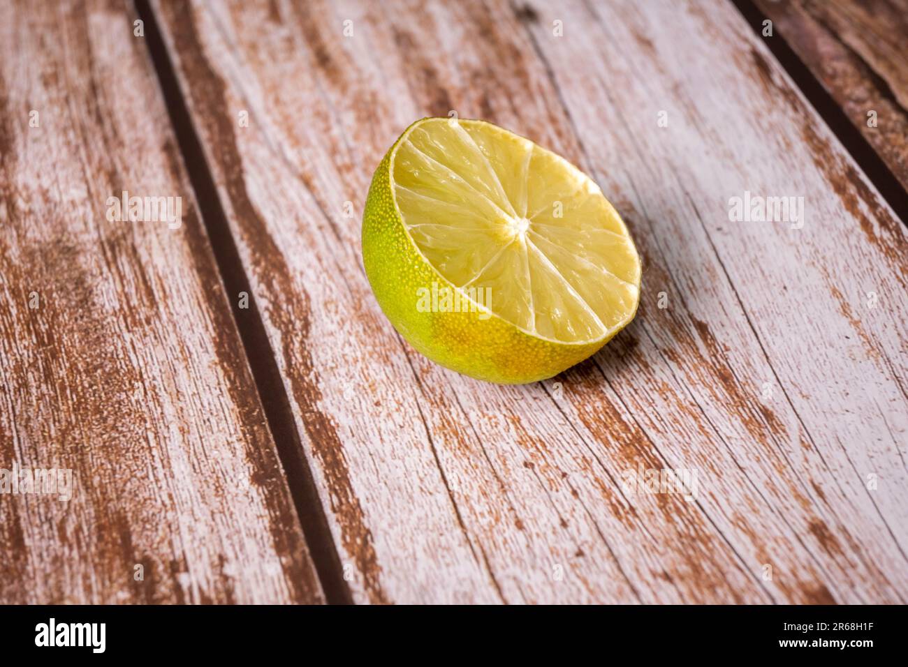Half an old lemon on a wooden floor Stock Photo - Alamy