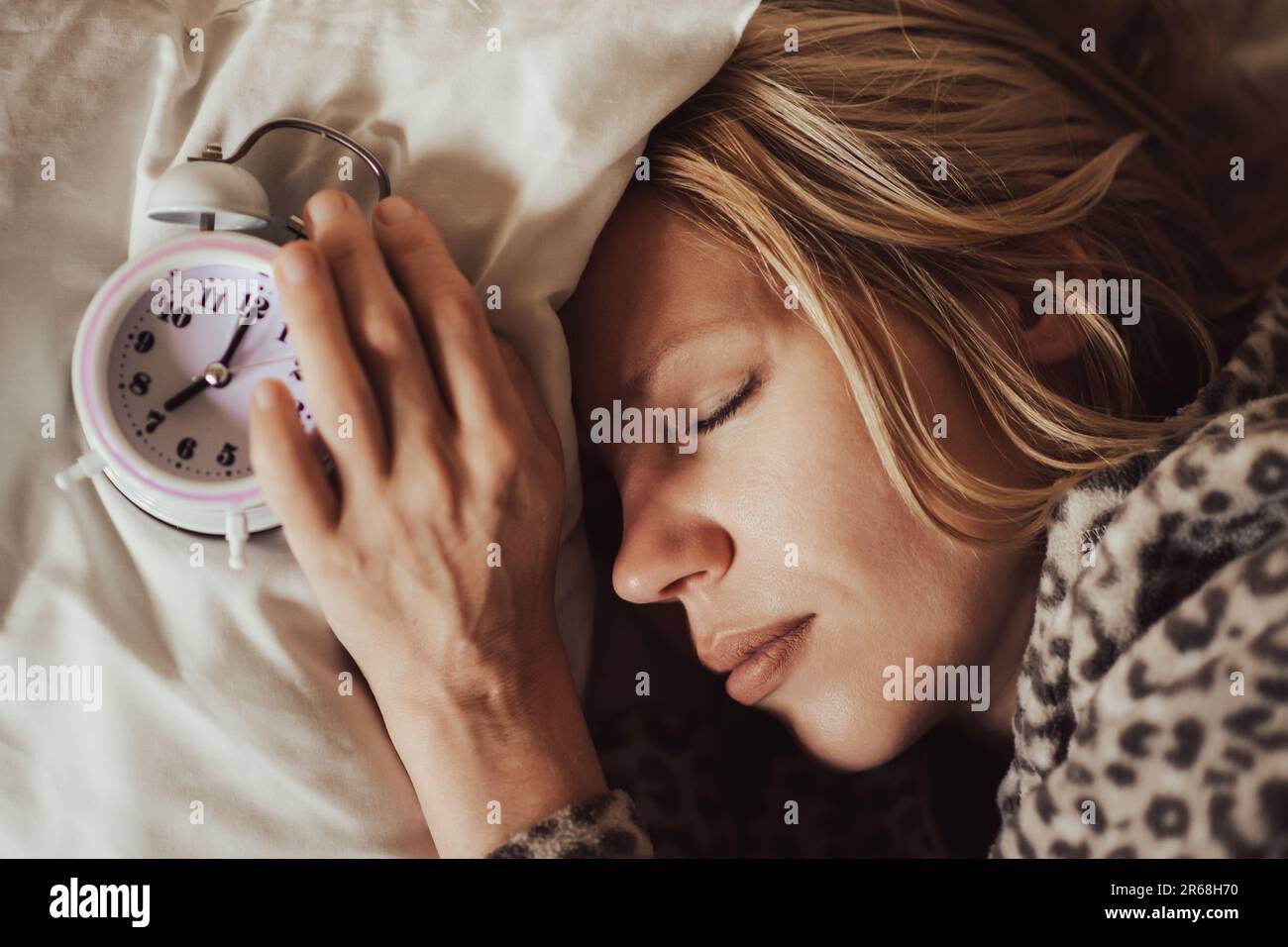 Alarm clock and sleeping woman. The concept of sleep problems, insomnia ... Alarm clock and sleeping woman. The concept of sleep problems, insomnia ...