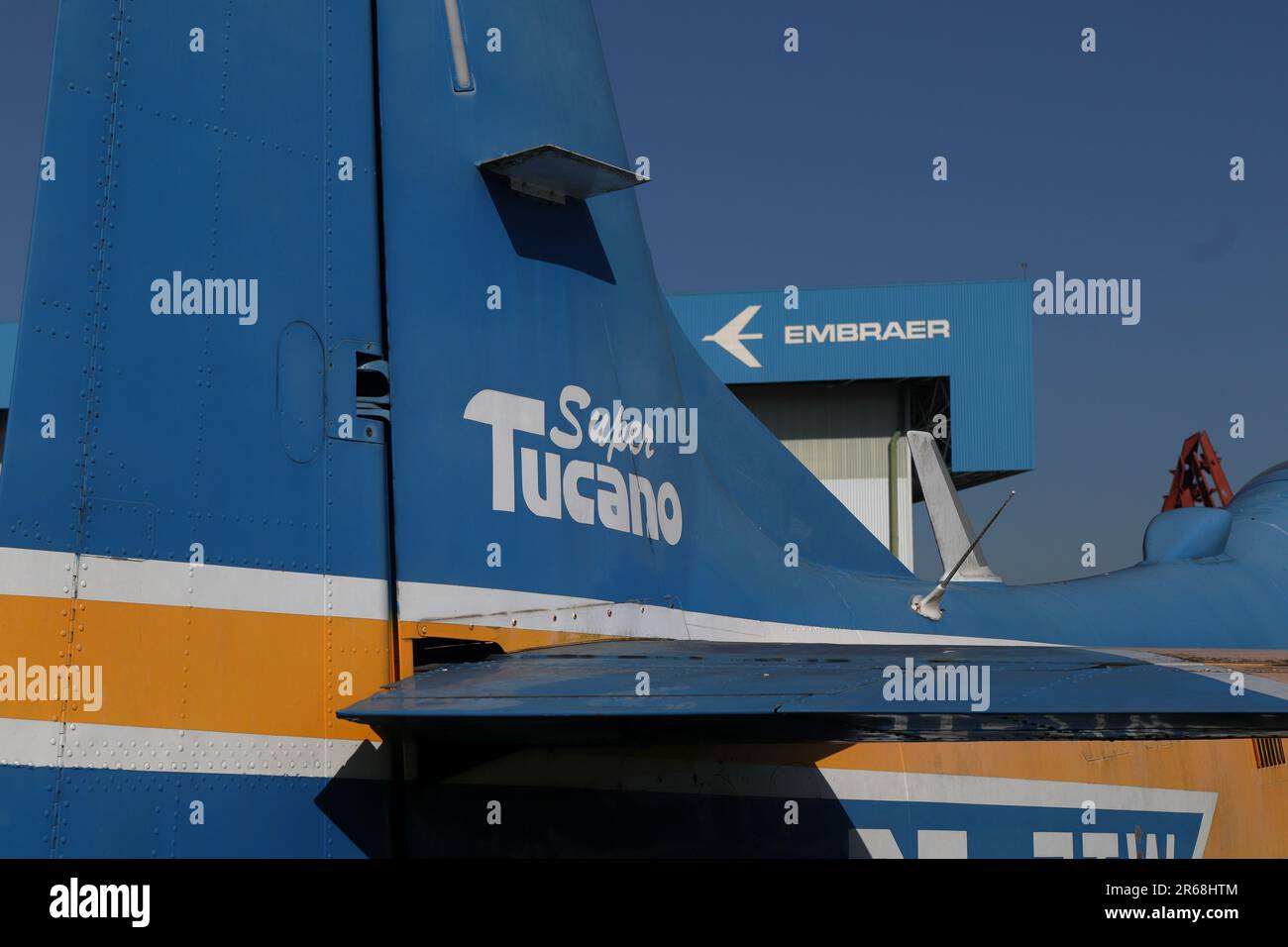 Partial view of a Supertucano plane in the foreground with the Embraer ...