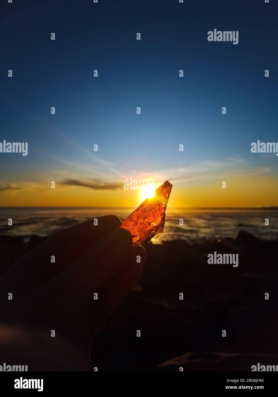 A vivid red crystal sparkles in the golden light of the setting sun ...