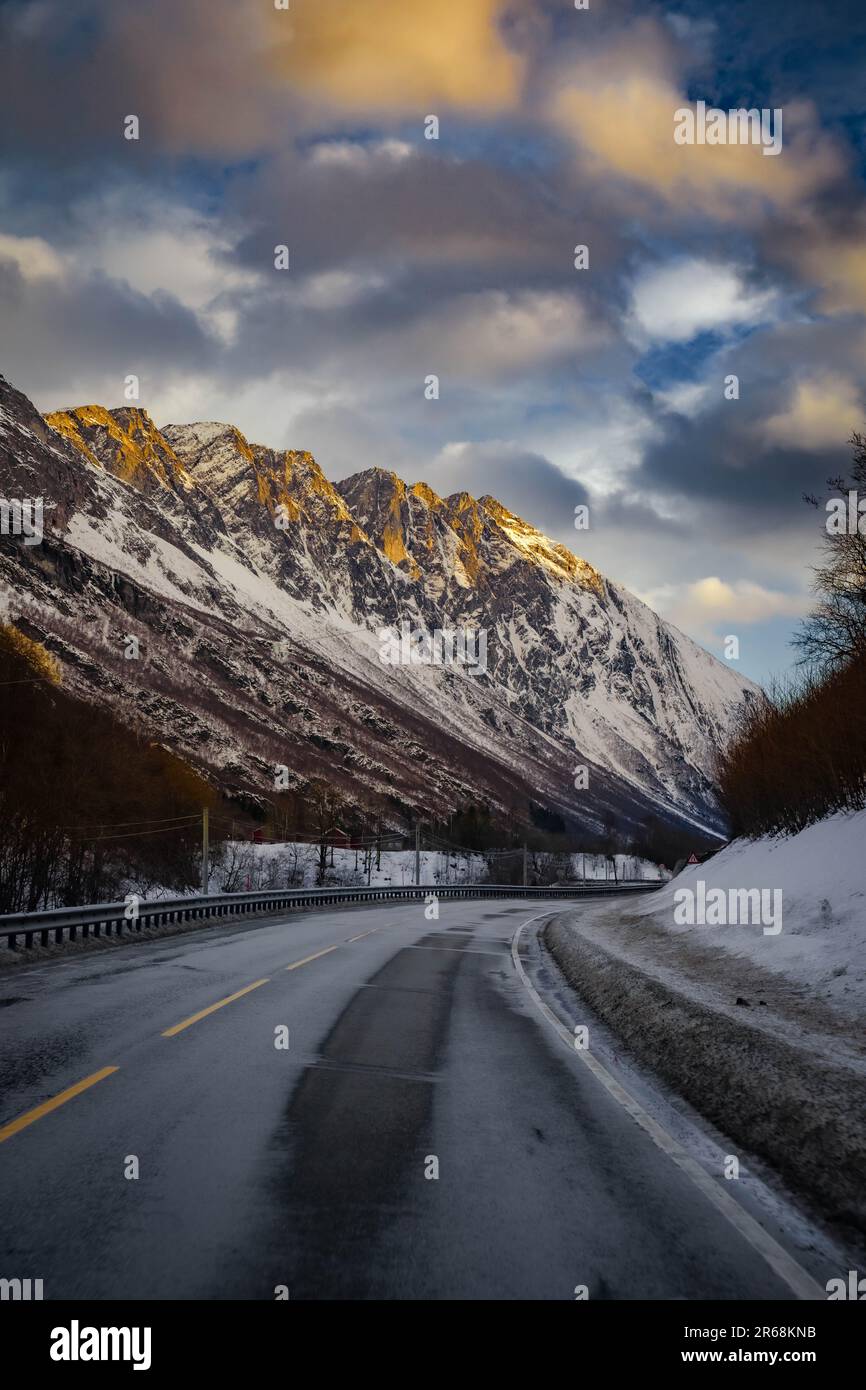 A vertical shot of a long road leading tothe Sunndal Mountains in ...