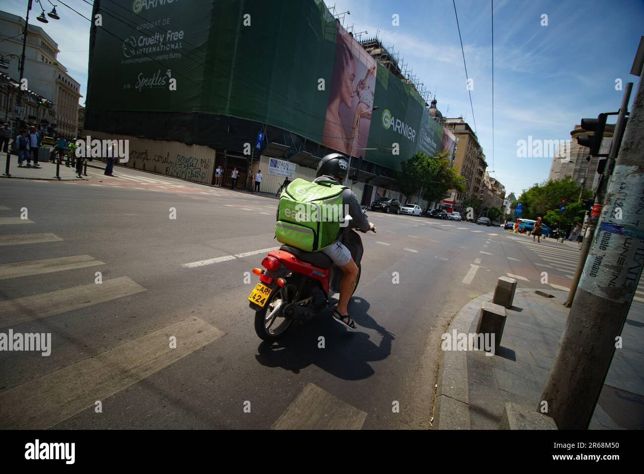 Bucharest, Romania. 7th June, 2023: A food delivery courier carrying an ...