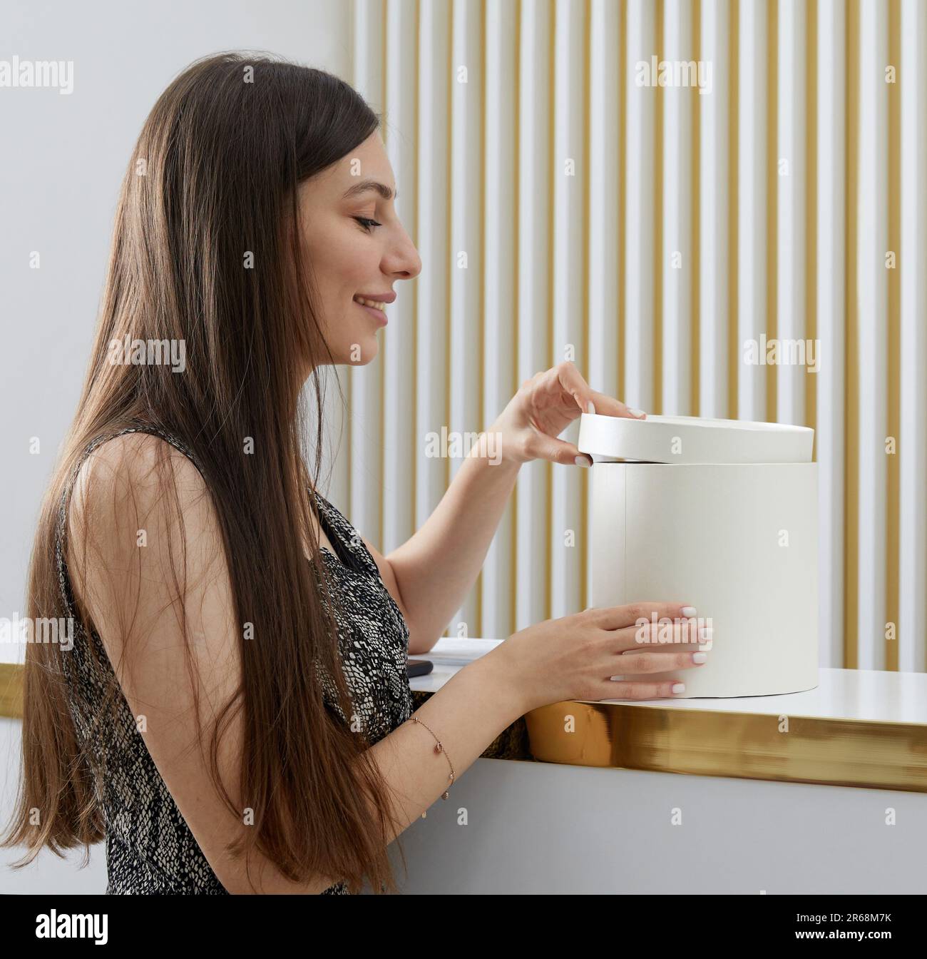 Female client in a modern office at reception desk Stock Photo - Alamy