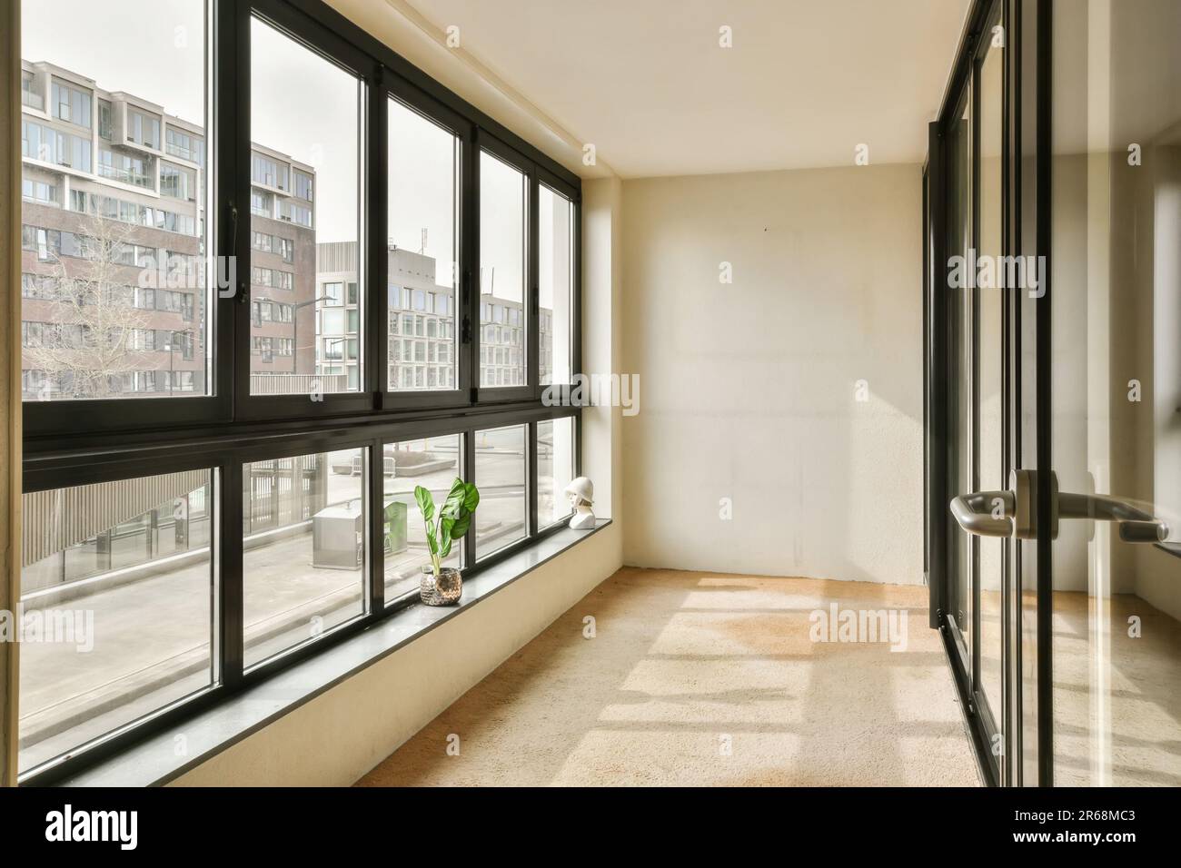 an empty room with large windows and plants in the window sid on the ...