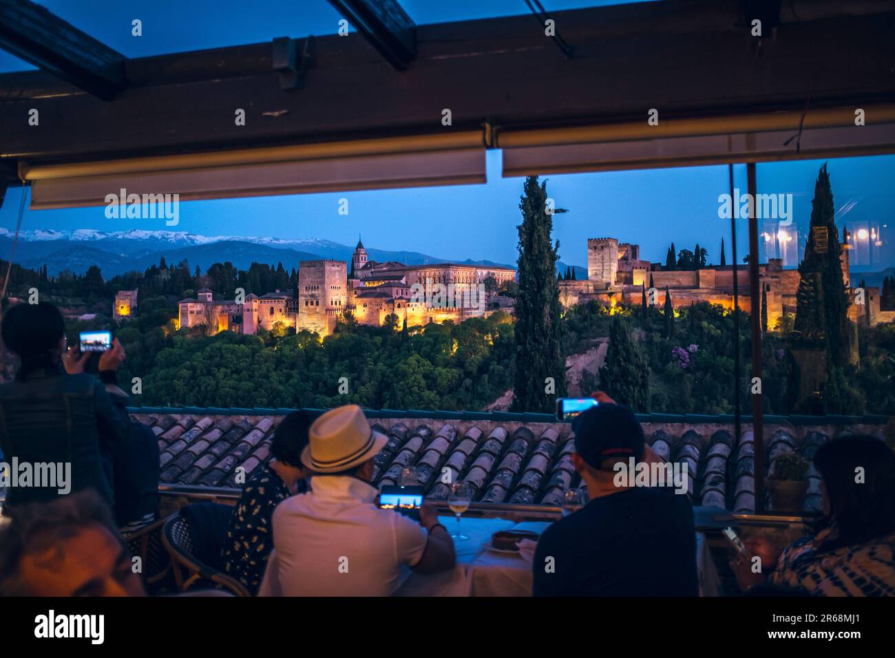 Photograph of the Alhambra at night illuminated from a bar Stock Photo ...