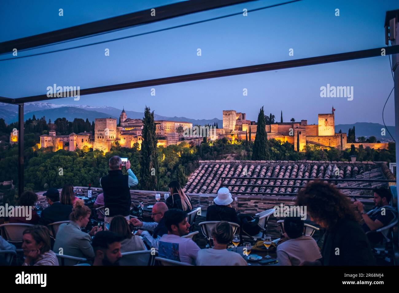 Photograph of the Alhambra at night illuminated from a bar Stock Photo ...