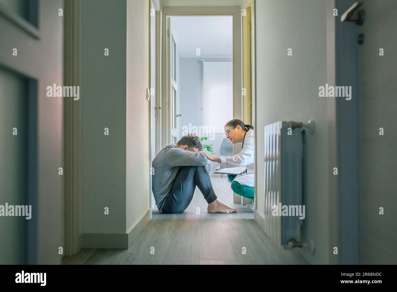 Doctor sitting on floor holding hi-res stock photography and images - Alamy