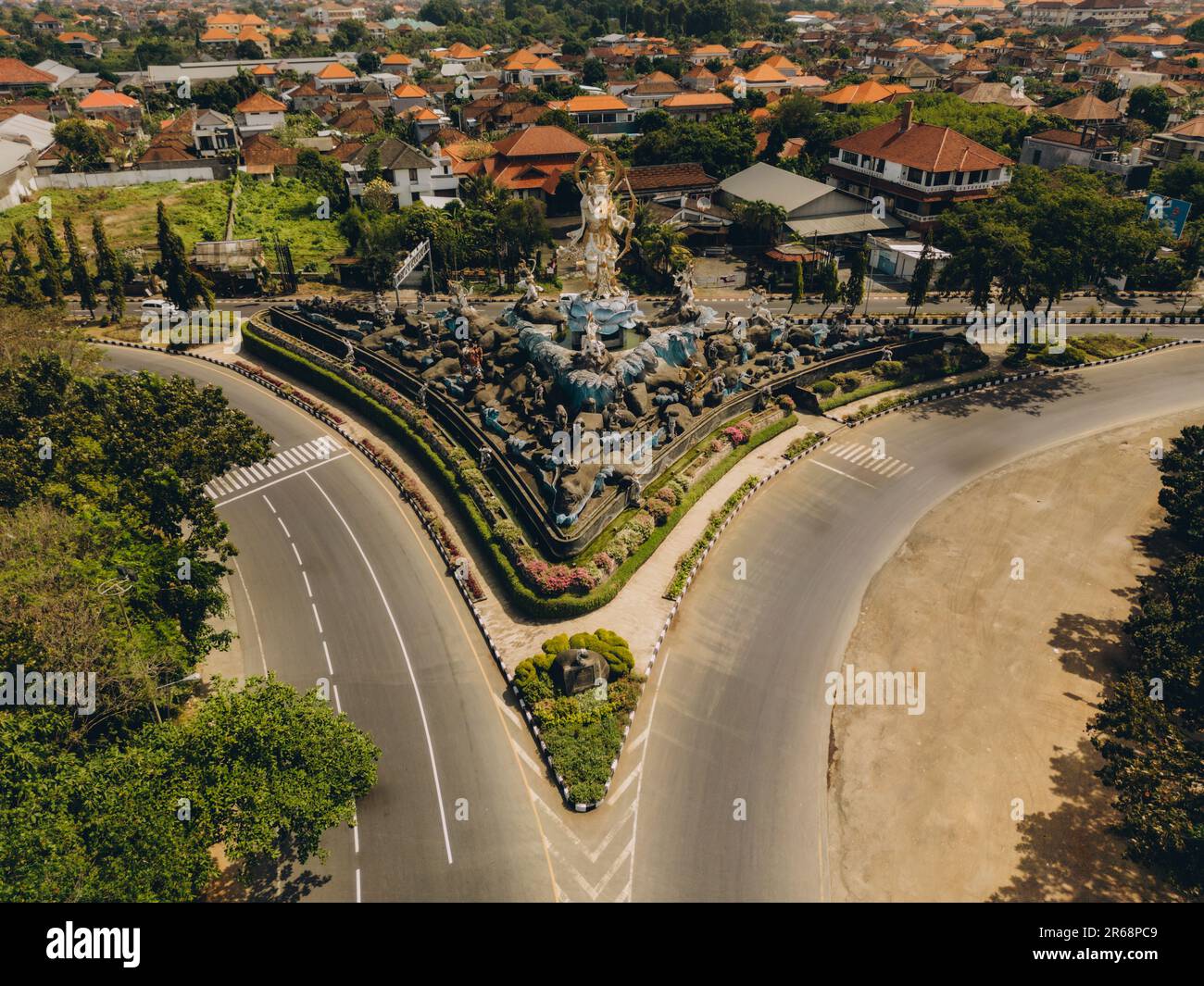 Aerial view of suburban area, road with trees, a stone balinese culture ...