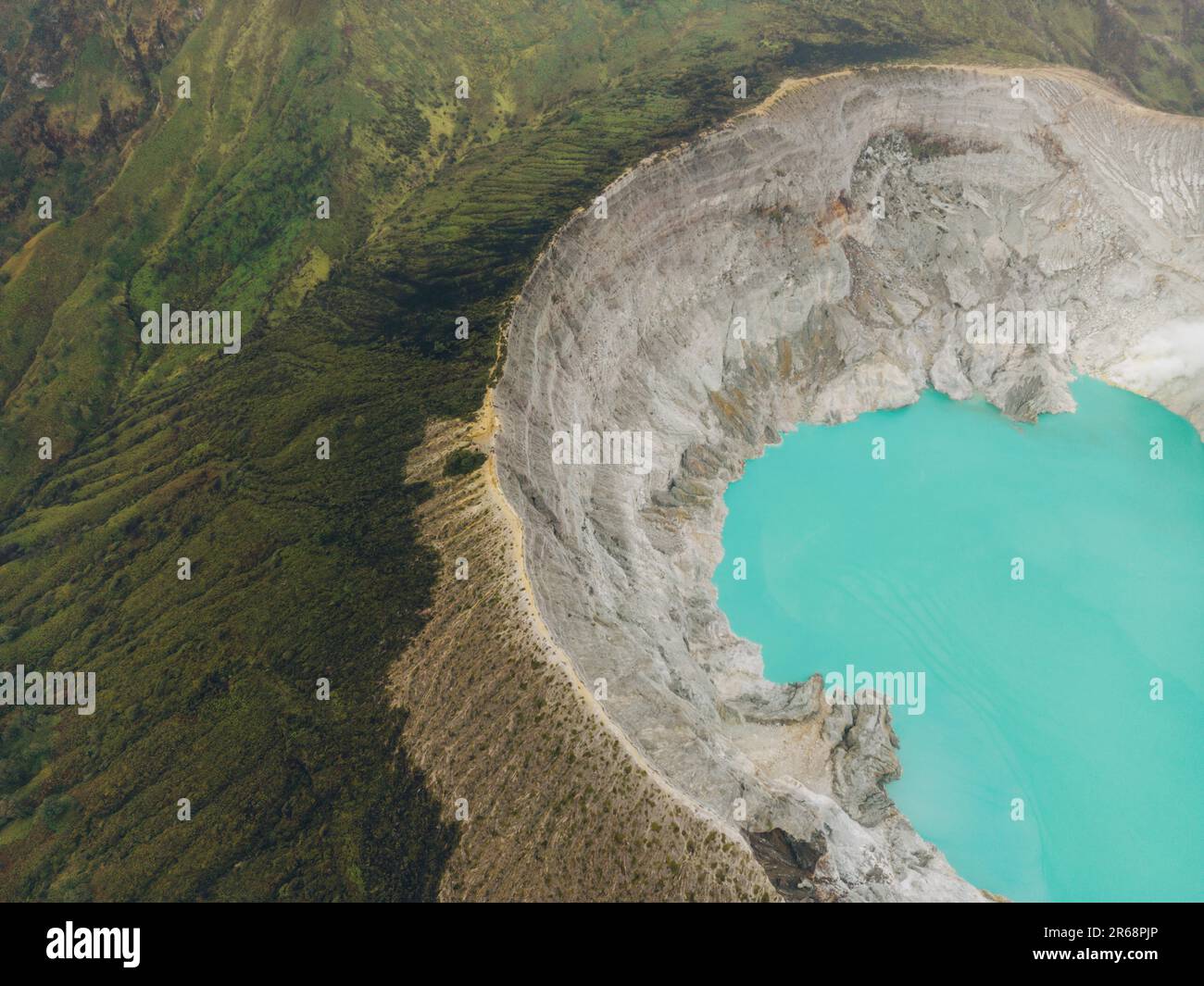 Top aerial view of turquoise sulfur water lake, surrounded by rock ...