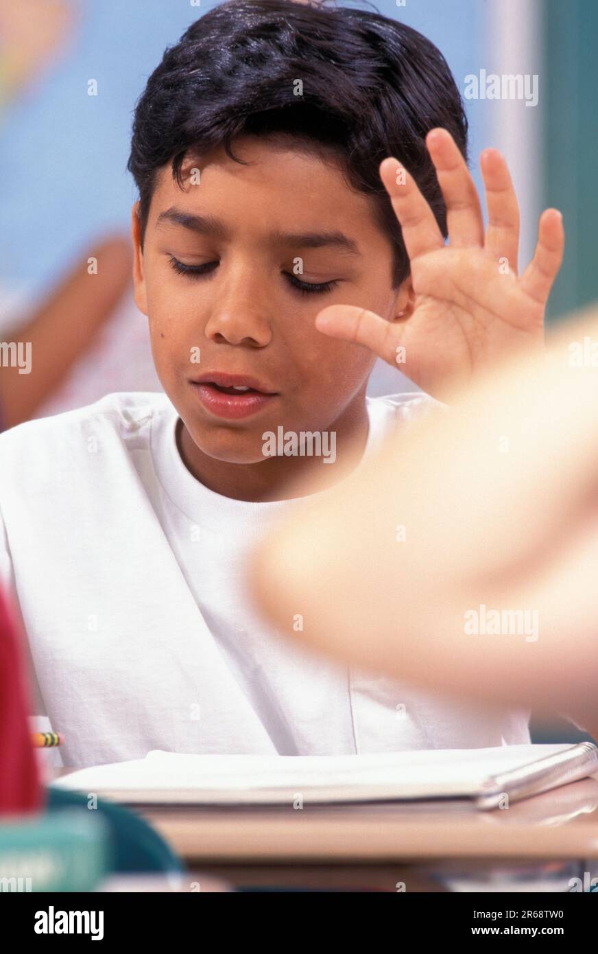 Latino student raising hand hi-res stock photography and images - Alamy