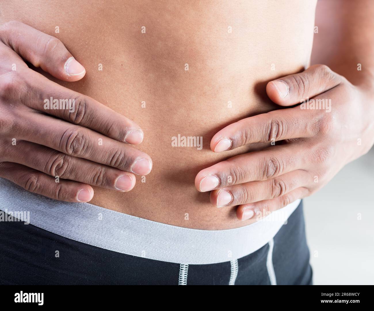 Man resting hands on stomach hi-res stock photography and images - Alamy
