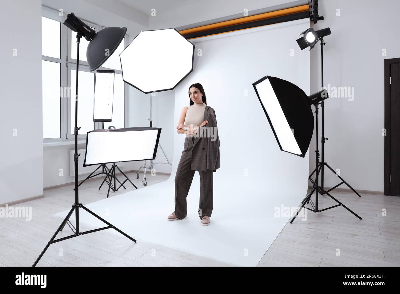 Beautiful young model posing in modern studio. Professional photo ...