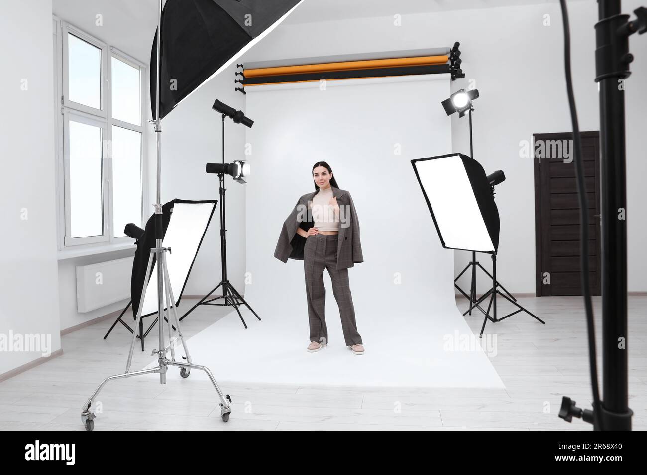 Beautiful young model posing in modern studio. Professional photo ...