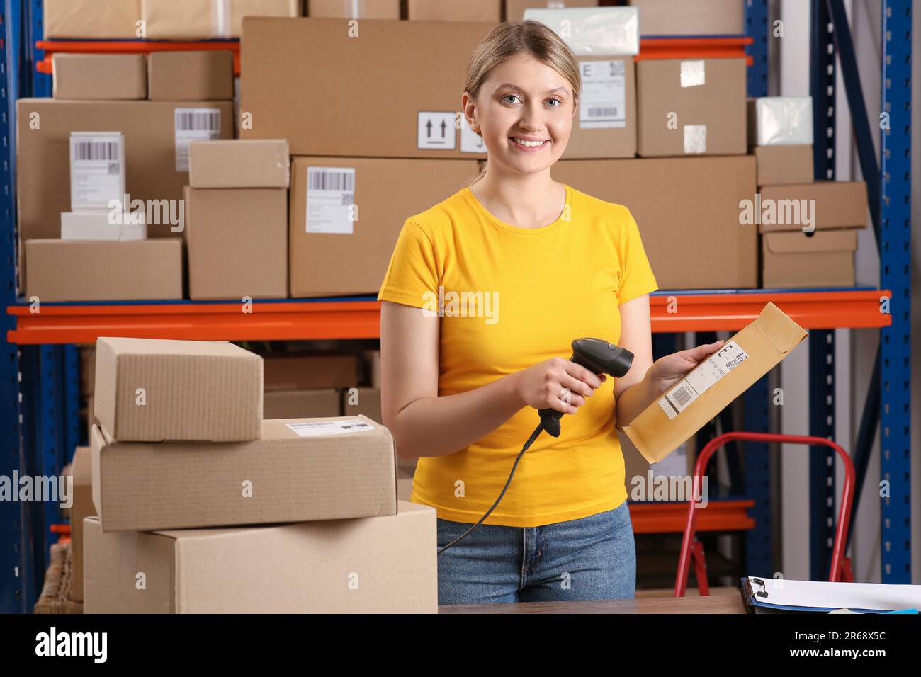 Post office worker with scanner reading parcel barcode indoors Stock ...