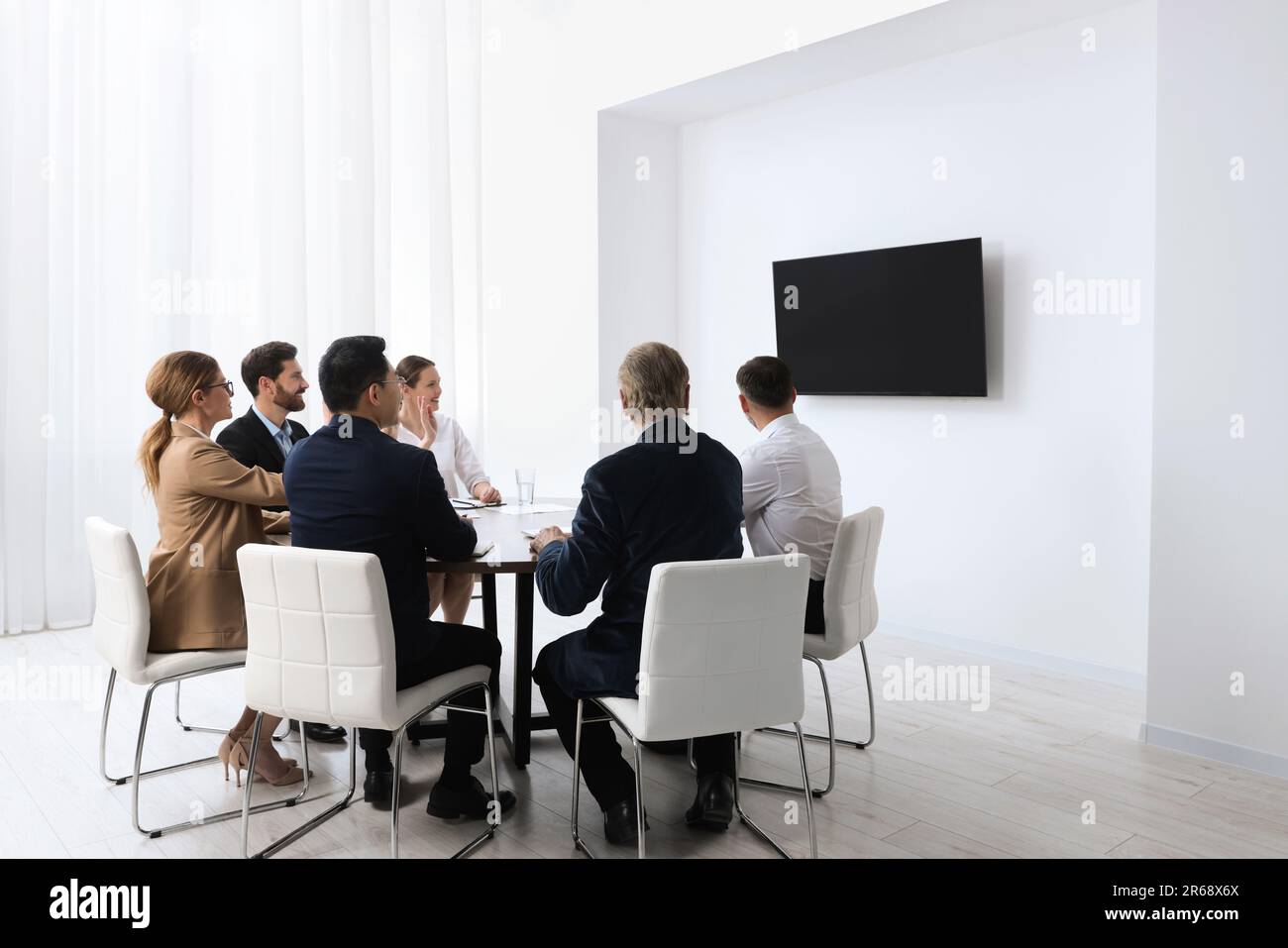 Business conference. Group of people watching presentation on tv screen ...