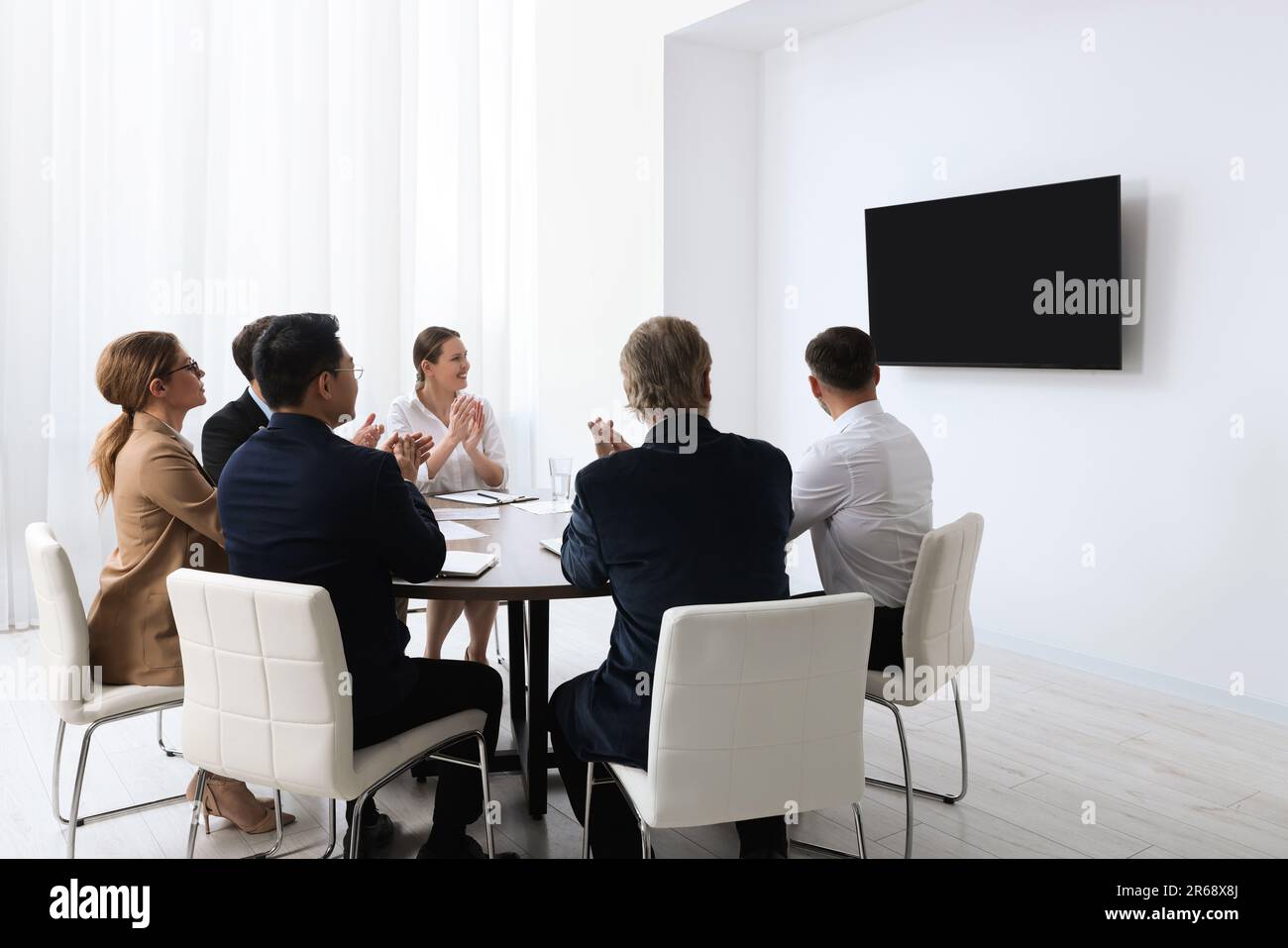 Business conference. Group of people watching presentation on tv screen ...
