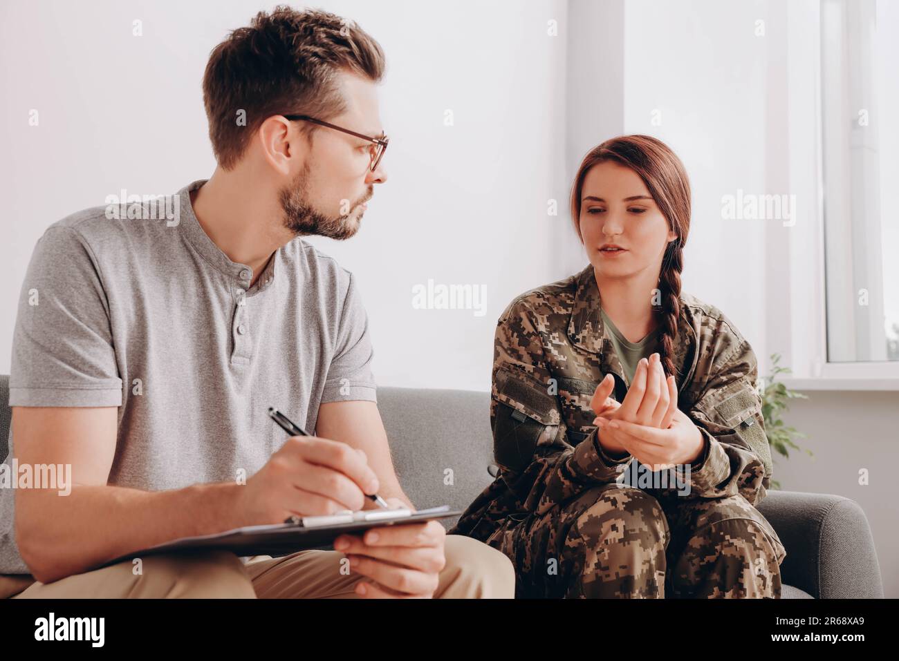 Female military officer talking with psychologist in office Stock Photo ...